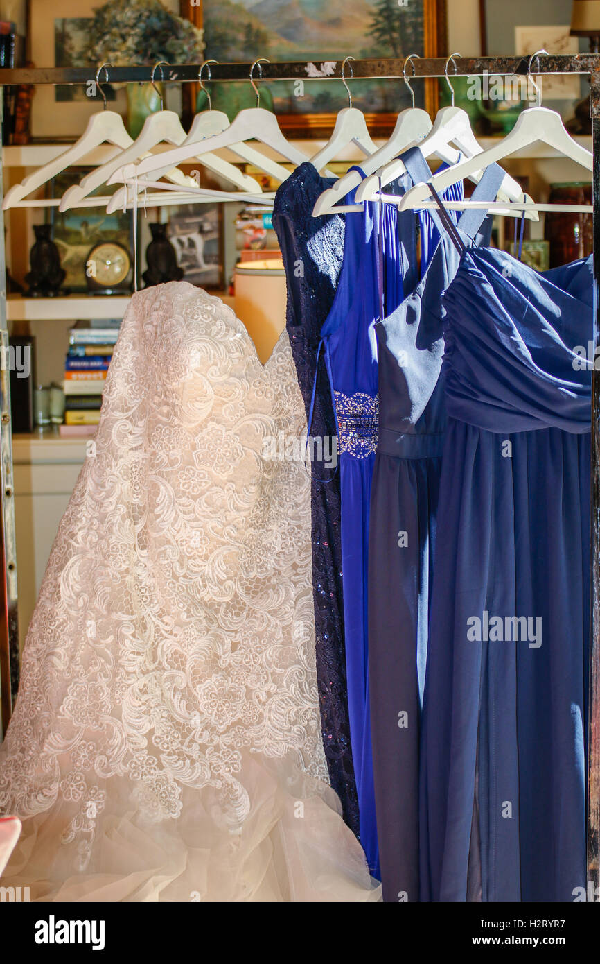Wedding dresses hanging on hangers ready to be worn Stock Photo - Alamy