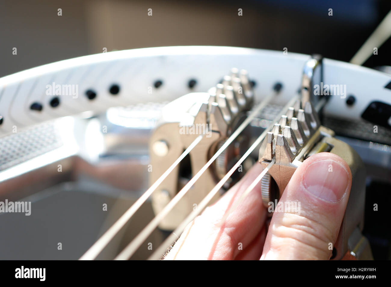 A older white male stringing a tennis racket Stock Photo - Alamy