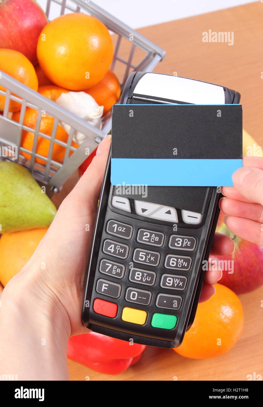 Hand using payment terminal with contactless credit card and fresh ...