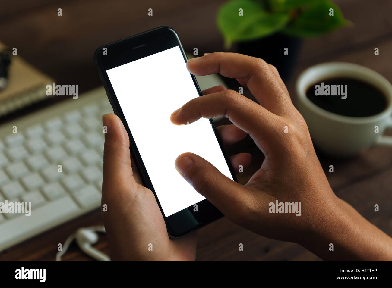 closeup hand use phone showing white screen on work desk, blank phone ...