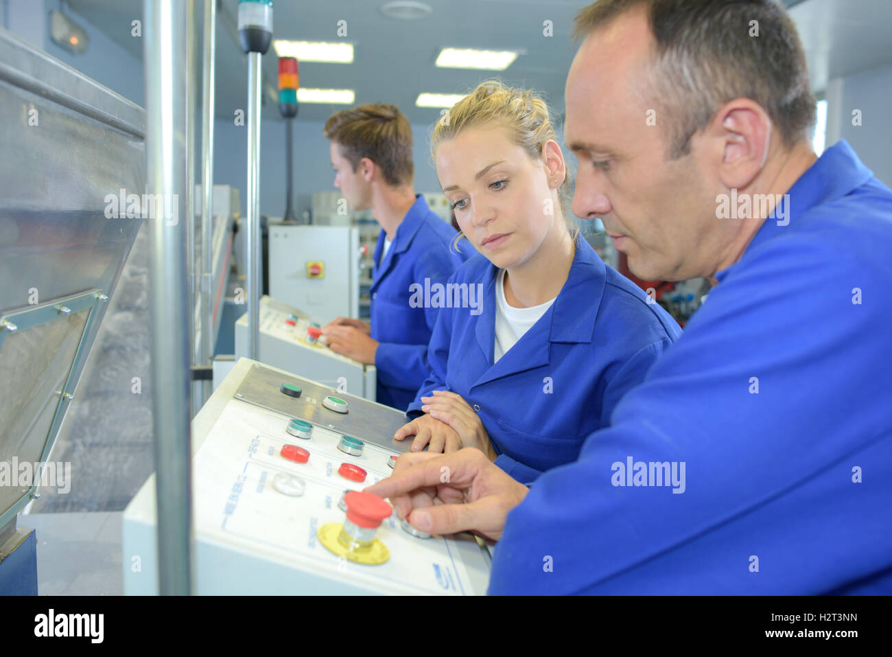 young machine tender observing Stock Photo - Alamy