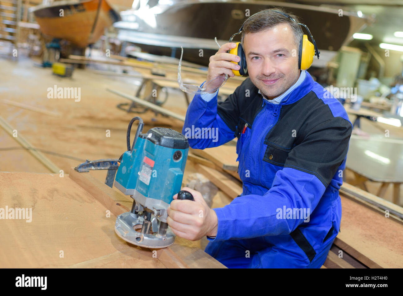 shipwright posing and smiling Stock Photo - Alamy