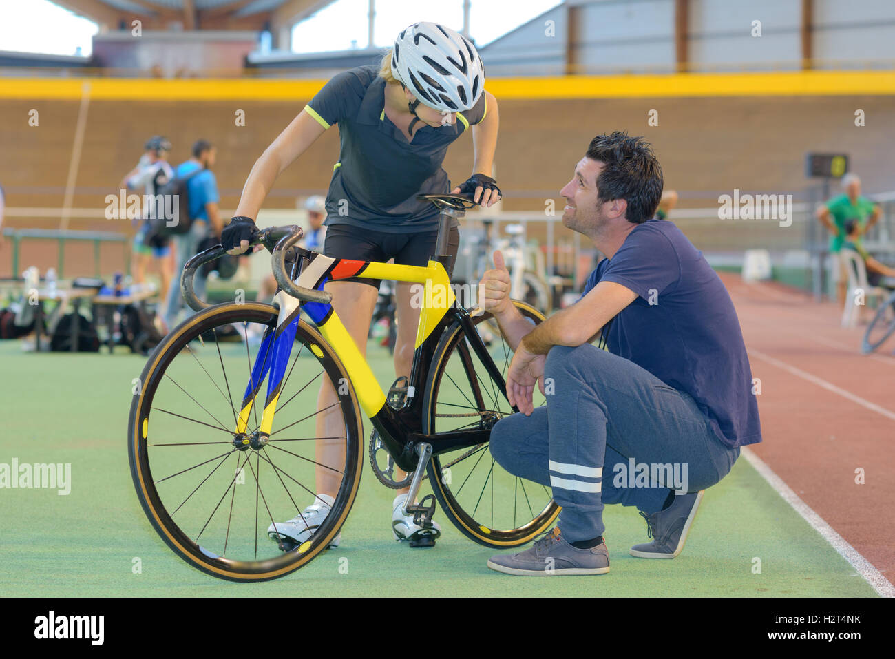 coach supporting a racing cyclist Stock Photo - Alamy