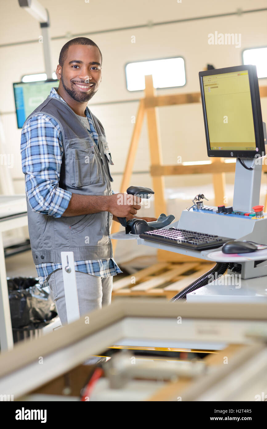 Male worker holding scanner Stock Photo - Alamy