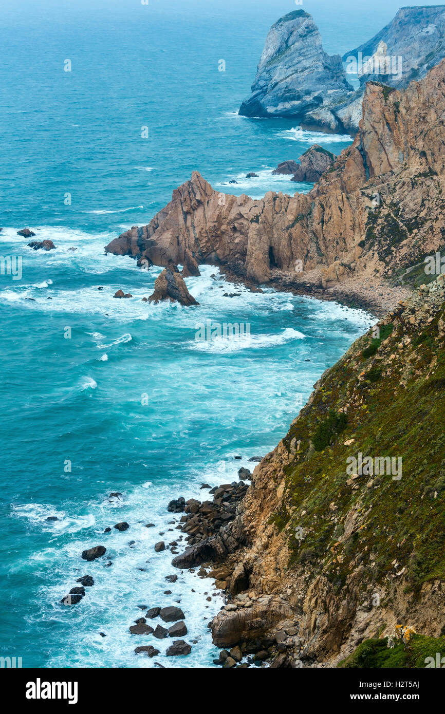Atlantic ocean coast (granite boulders and sea cliffs) in cloudy ...