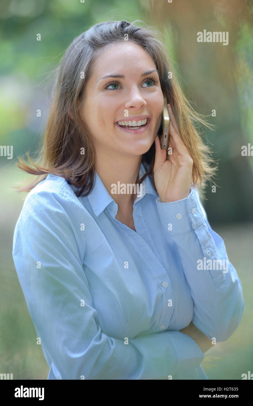Smiling lady on telephone outdoors Stock Photo - Alamy