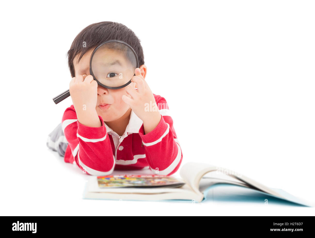 surprised kid looking through from magnifying glass Stock Photo - Alamy