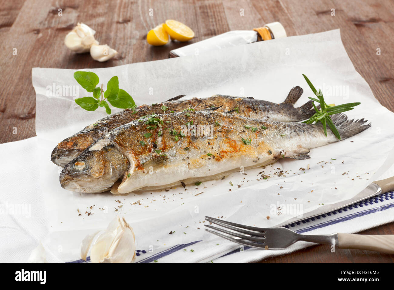 Two grilled trouts with fresh herbs Stock Photo - Alamy