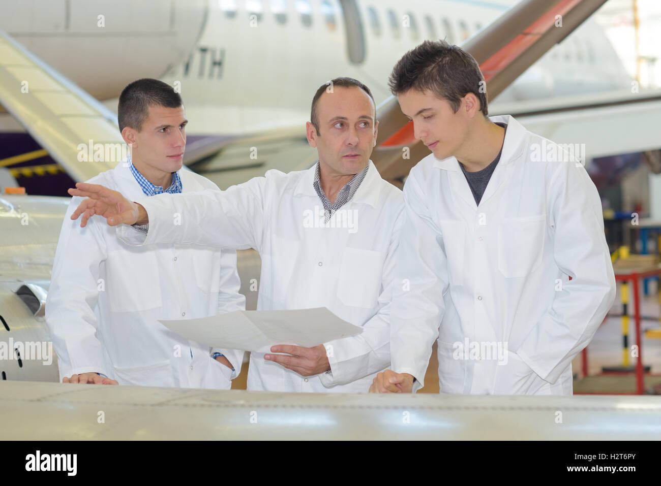 Man directing junior workers Stock Photo - Alamy