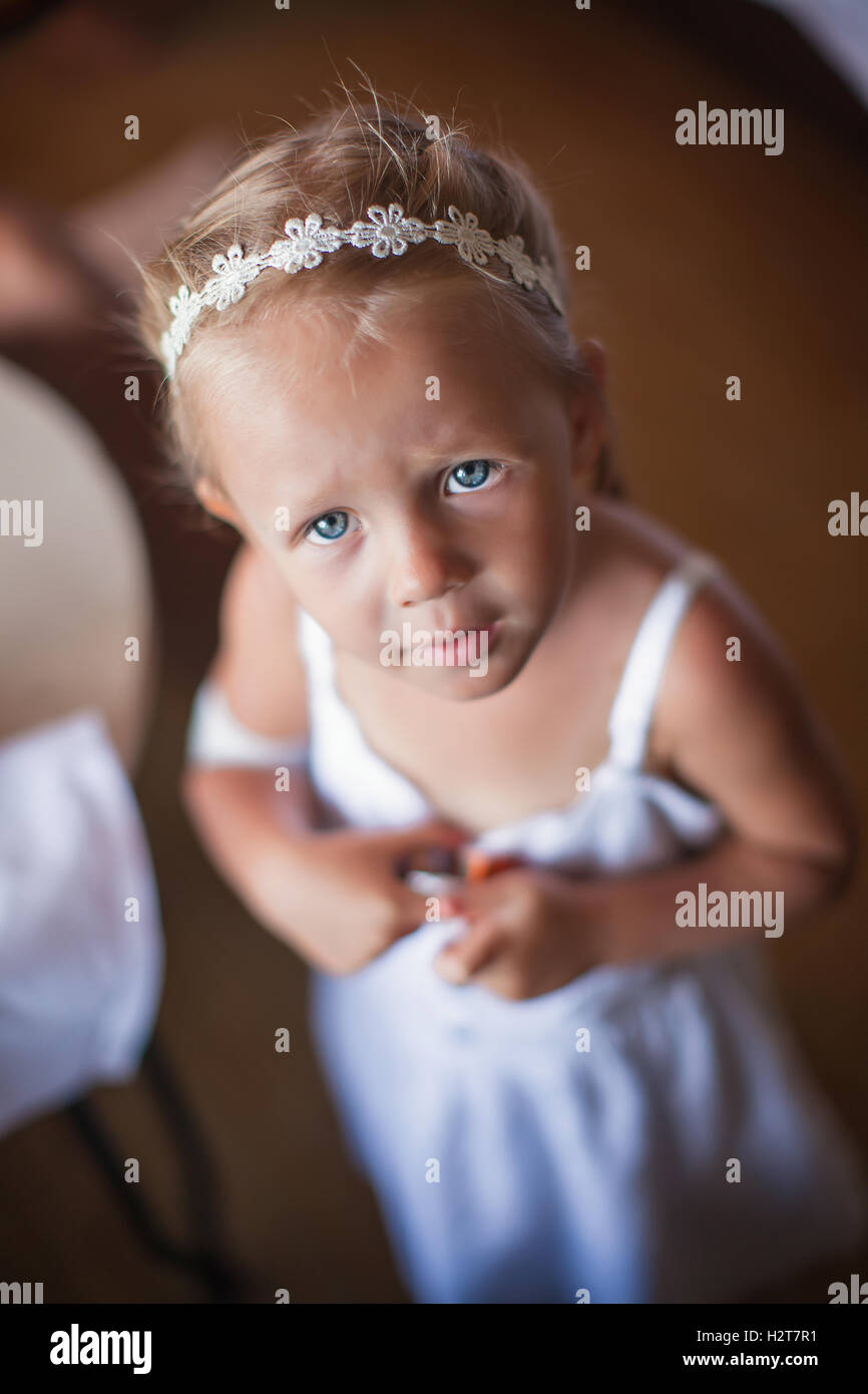 Portrait of little adorable girl looking at camera Stock Photo - Alamy