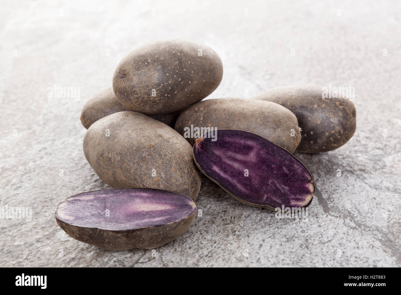 Raw purple potatoes Stock Photo - Alamy