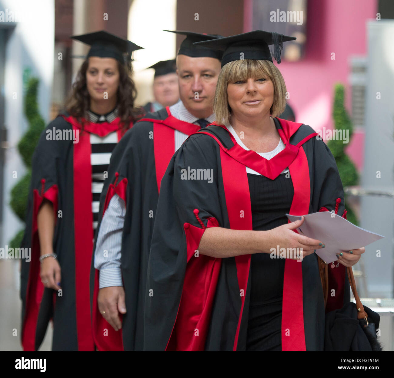 University degree students wearing mortarboards and gowns during a ...