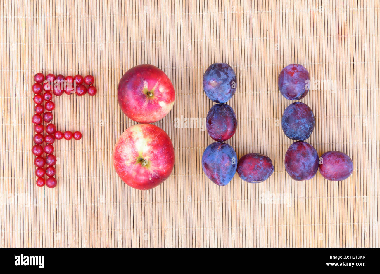 Word FALL made of ripe colorful berries and fruits - apples, plums and ...