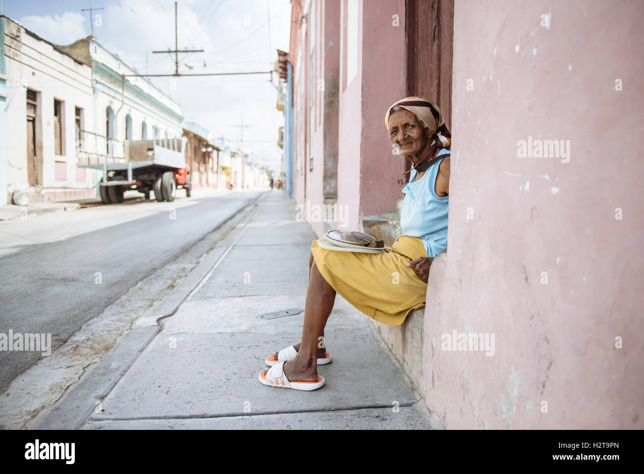 An elderly Cuban woman having meal in the street. Santiago de Cuba ...