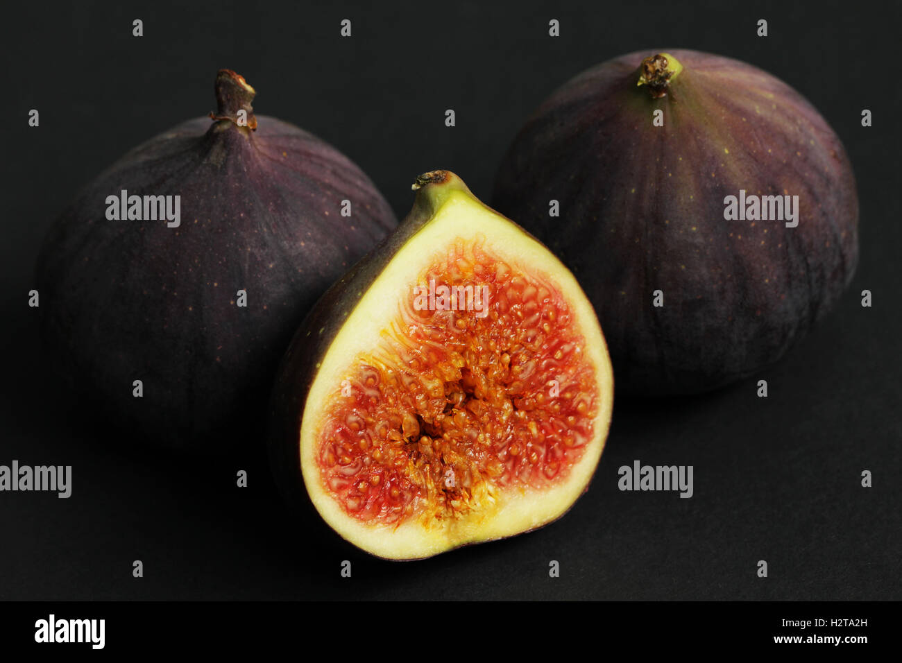 Fresh figs isolated on black beautiful food background Stock Photo - Alamy