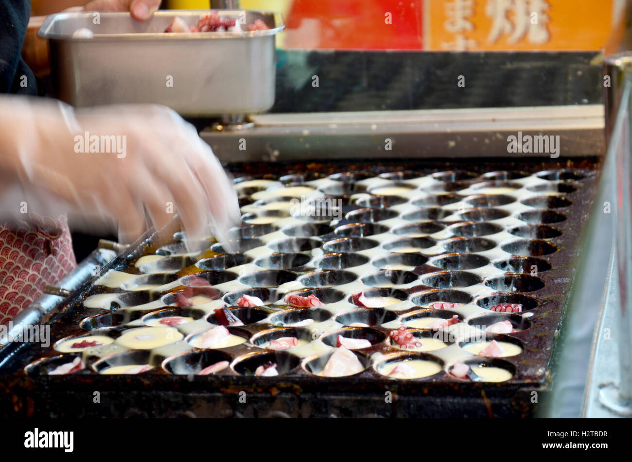 Japanese chef cooking takoyaki is a ball shaped Japanese snack for sale ...