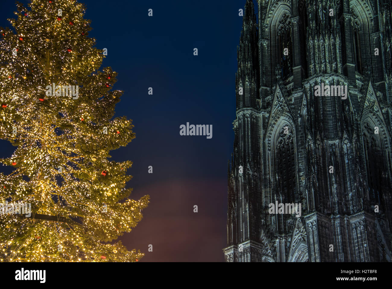 part of cologne cathedral and part of glistening christmas tree with ...
