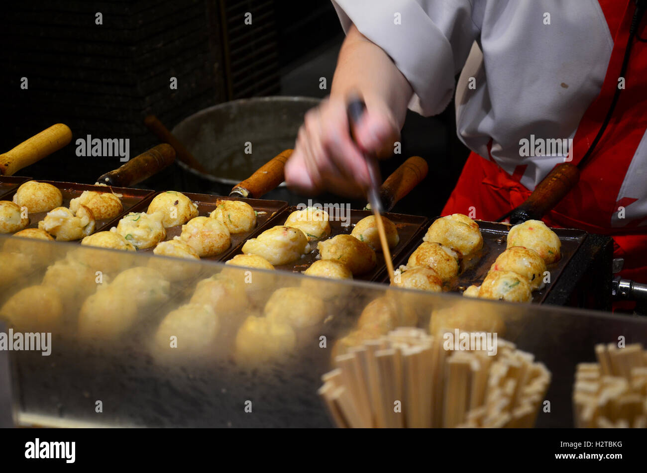 Japanese chef cooking takoyaki is a ball shaped Japanese snack for sale ...