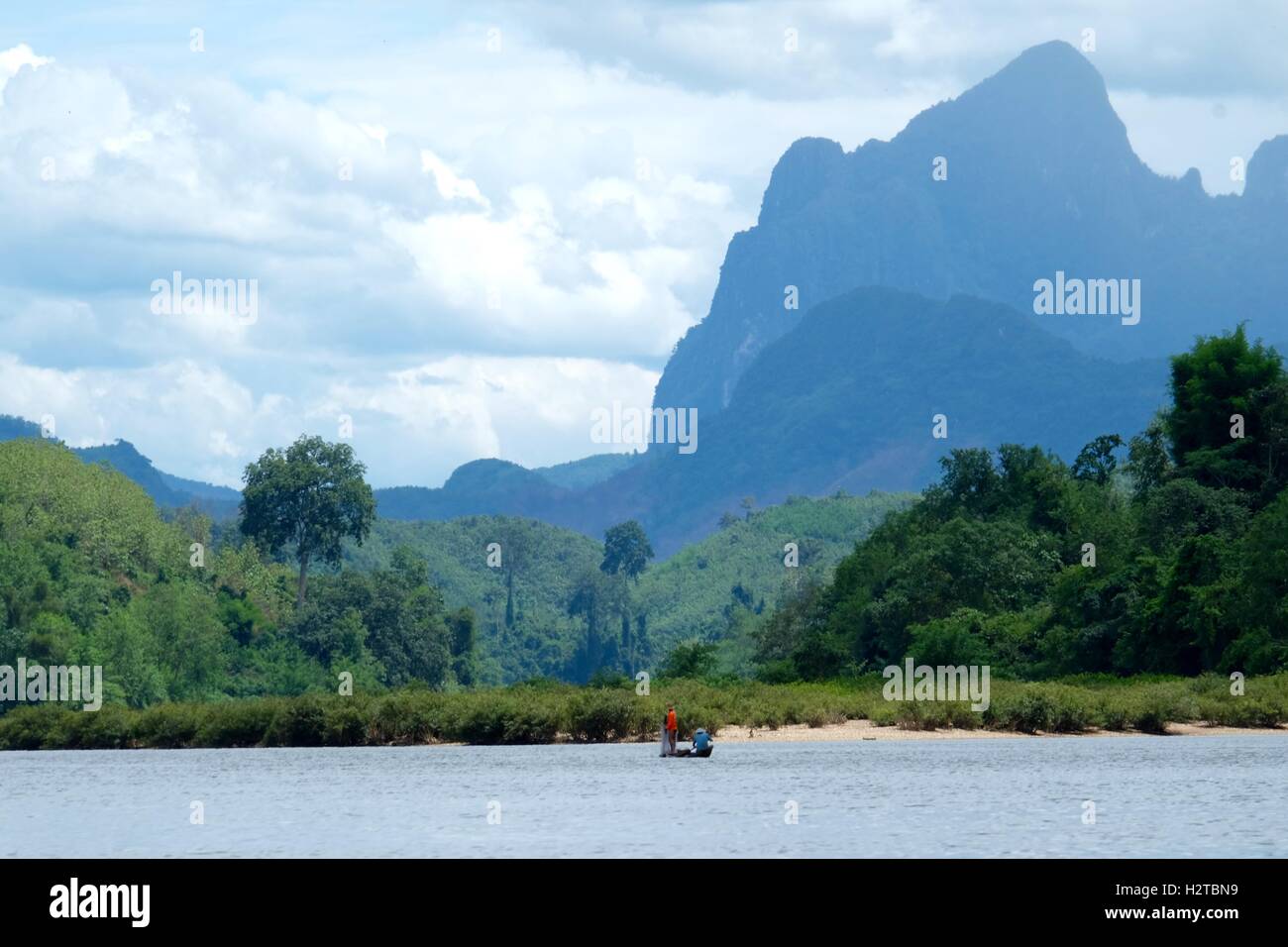 Landscape on Nam River with small boat - Laos Stock Photo - Alamy
