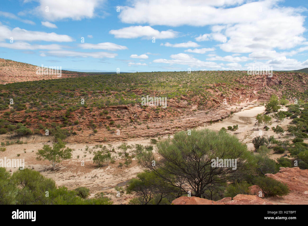 Wide open landscape with red sandstone bluffs and bushland in Kalbarri ...