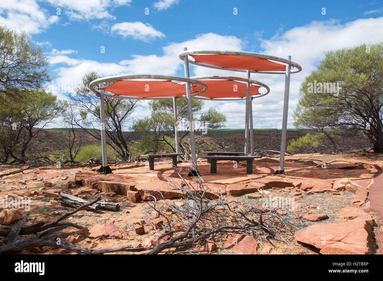 Modern sun shade with benches at Kalbarri National Park with red ...
