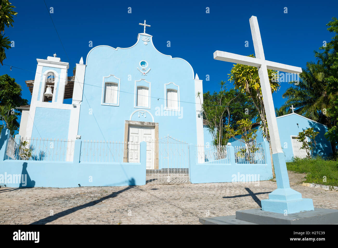 Traditional colonial church architecture with simple Christian cross on ...