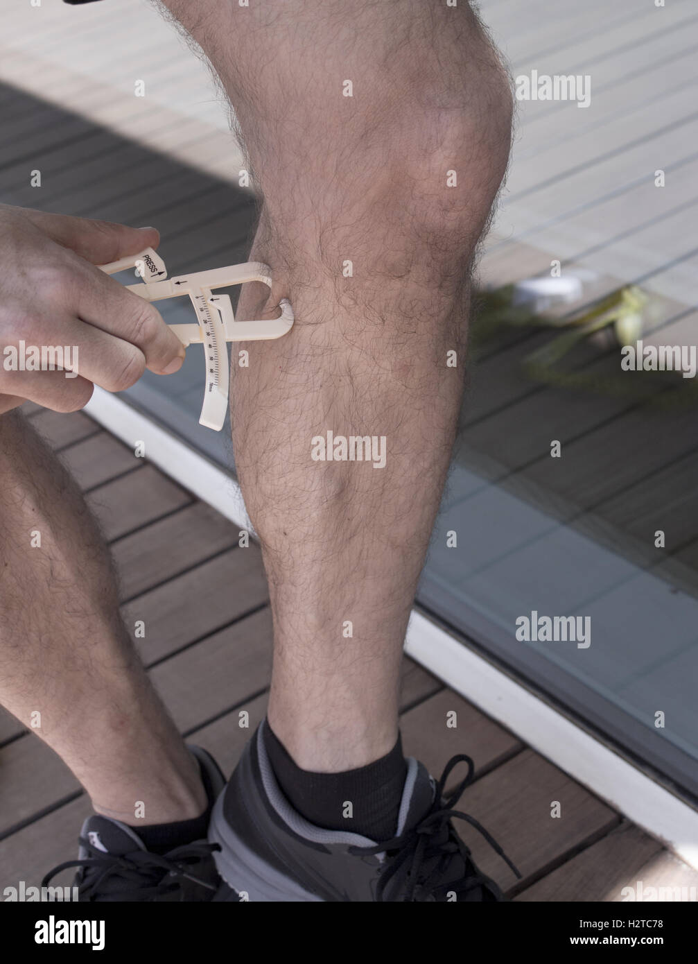 Body of a man measuring contour and body fat Stock Photo - Alamy