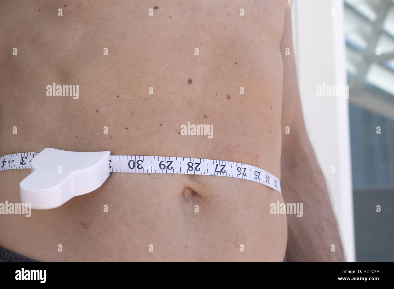 Body of a man measuring contour and body fat Stock Photo - Alamy