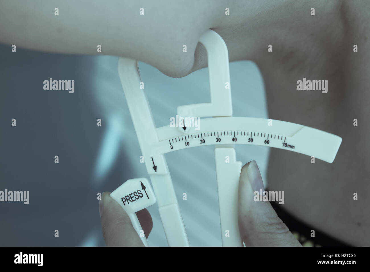 Part of the body of a woman measuring contour and body fat Stock Photo ...