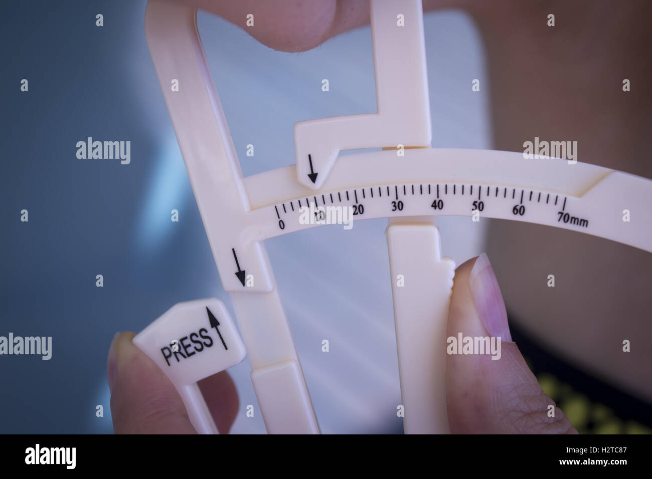 Part of the body of a woman measuring contour and body fat Stock Photo ...