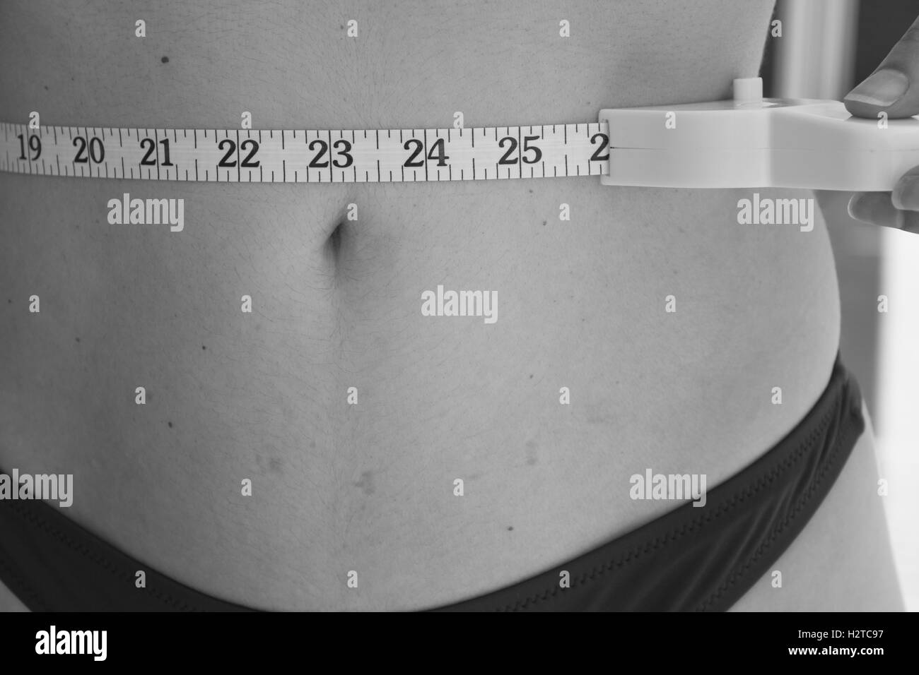 Measuring stomach woman Black and White Stock Photos & Images - Alamy