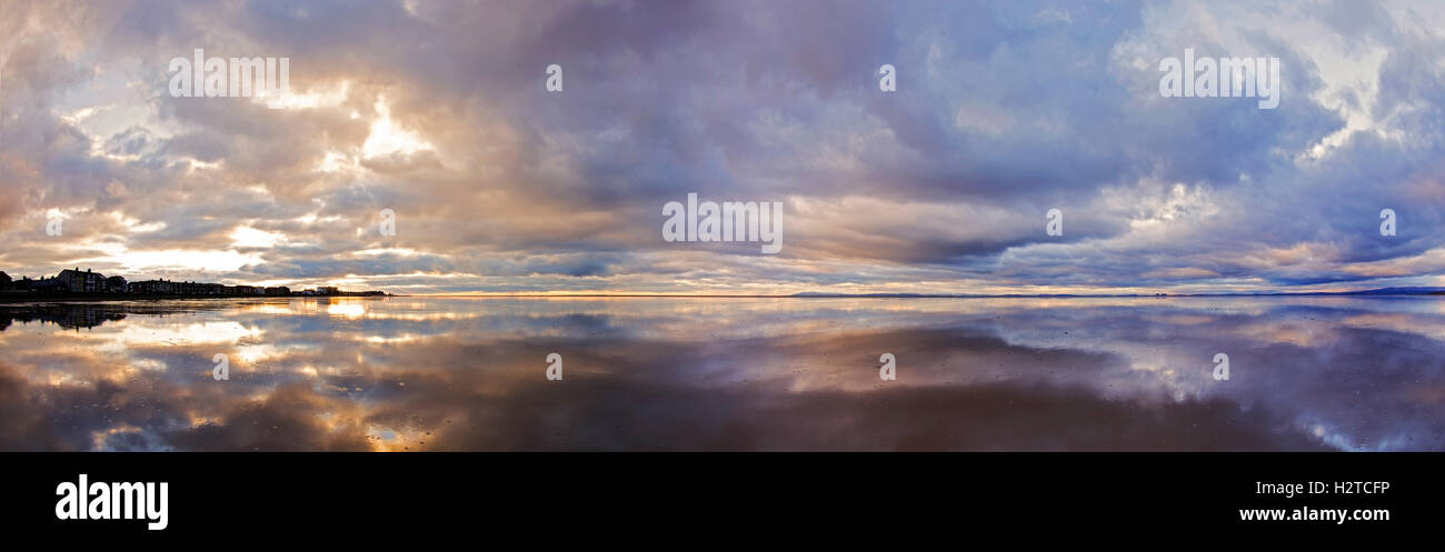 Panoramic view of Sunset reflected in the wet sands of Morecambe Bay ...
