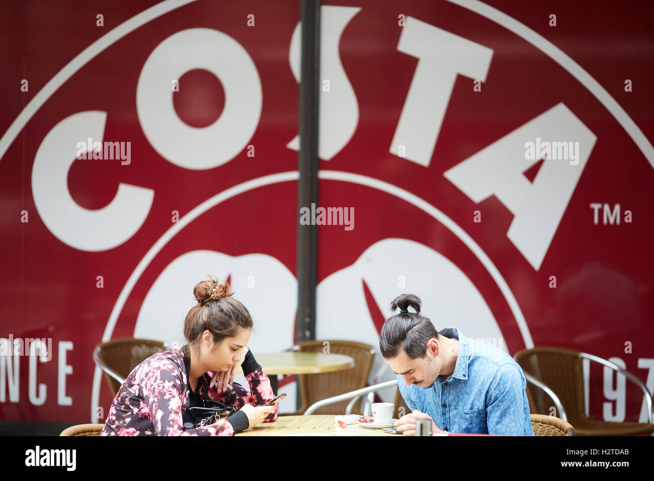 Costa coffee logo sign customers pavement exterior drinking street ...