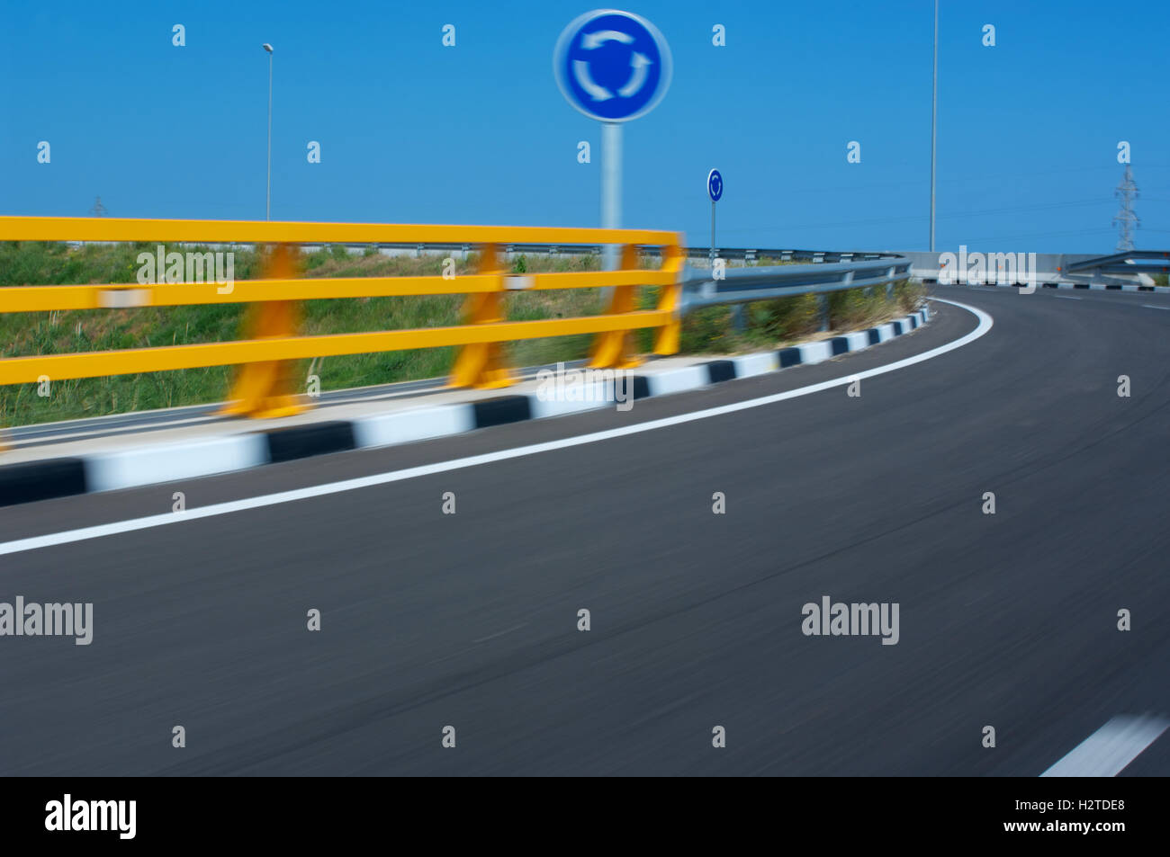 Traffic roundabout with signs Stock Photo - Alamy