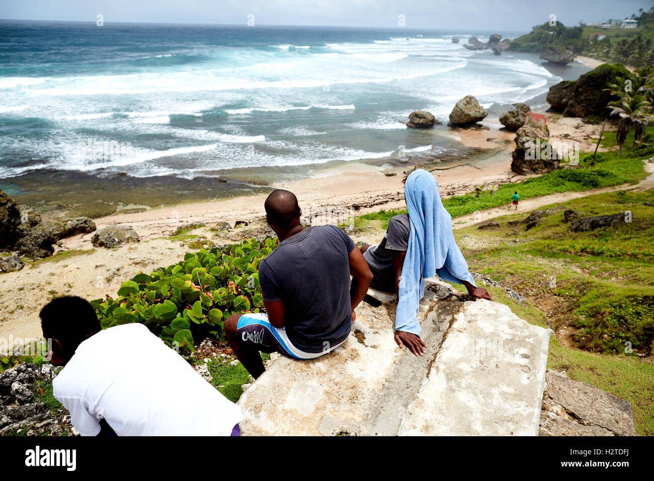 Barbados atlantic coast view ocean local men boys sat looking out to ...