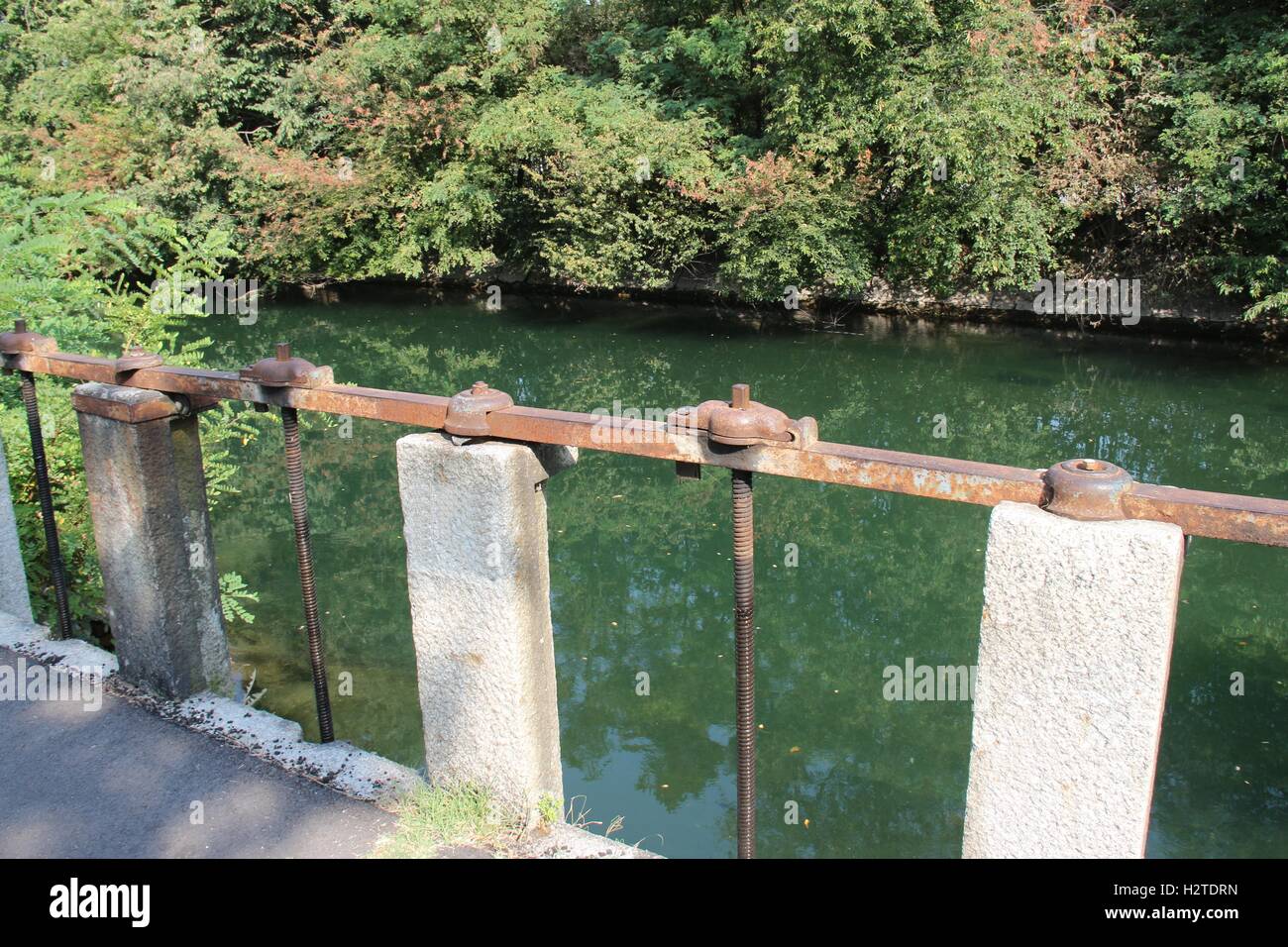 Old screw and nut - part of the lock mechanism of dam, varnished green ...