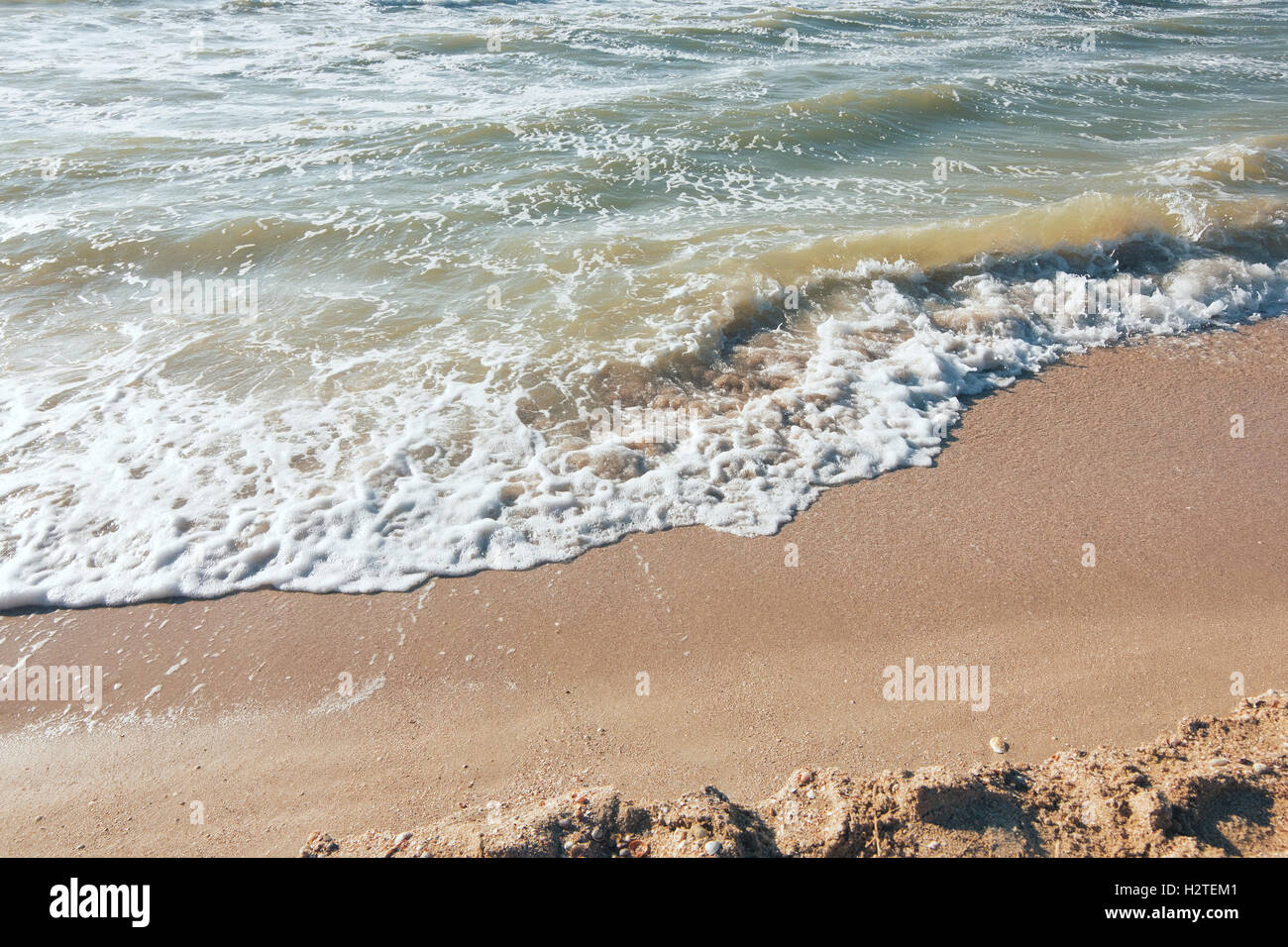 Summer time blue sea waves yellow sun and sand Stock Photo - Alamy