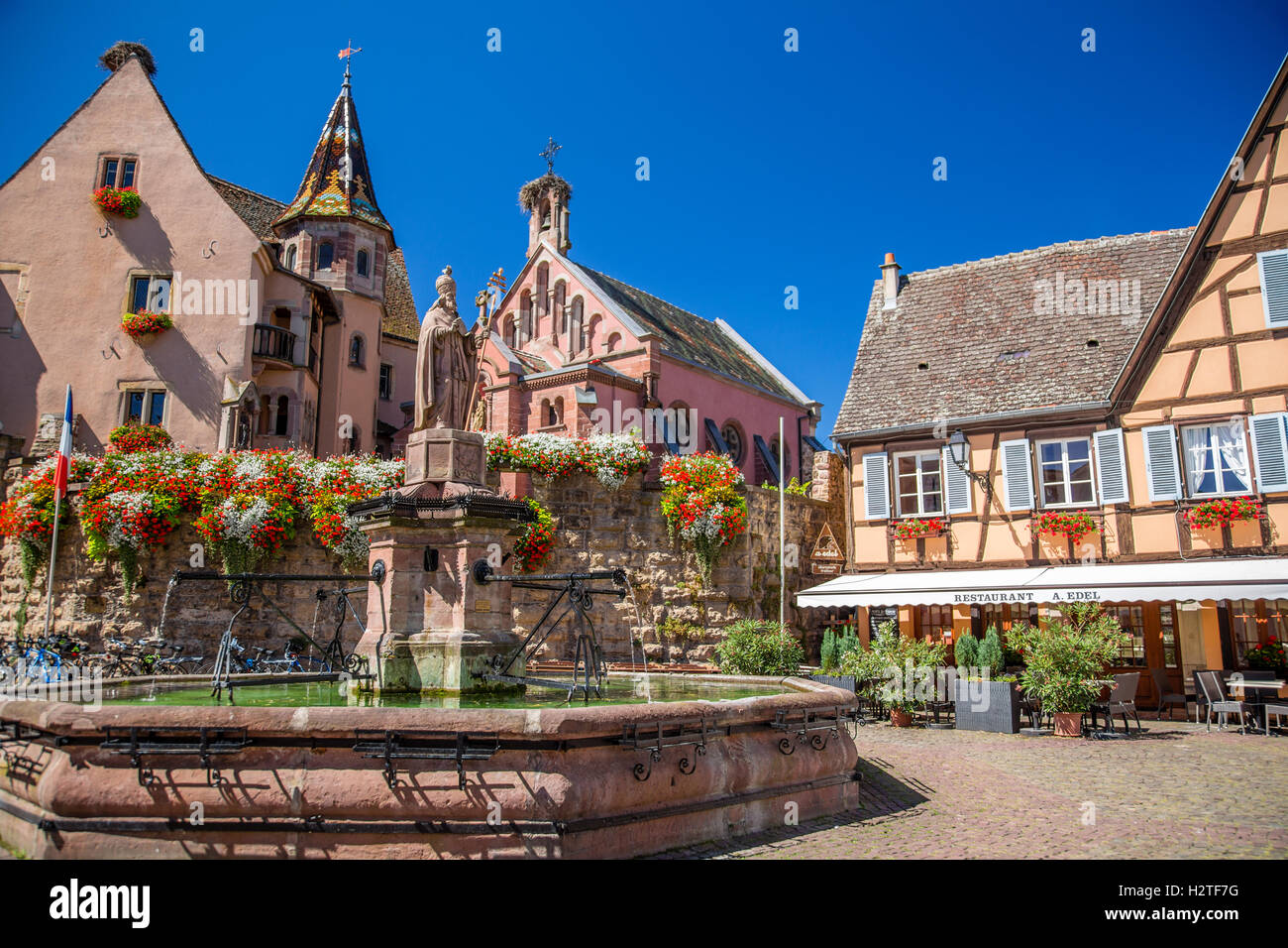 Fountain in the village centre on the wine route, Eguisheim, Alsace ...