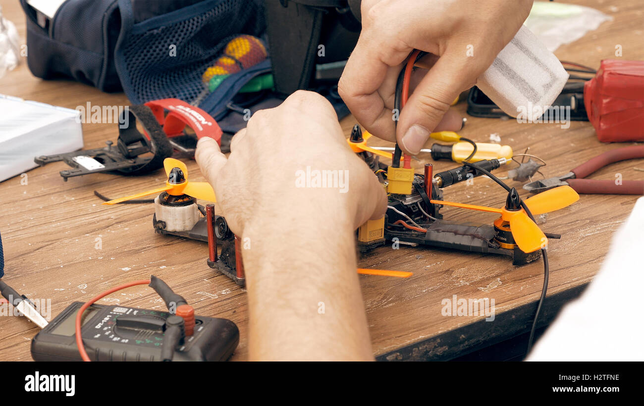 Man assembling FPV drone using tools Stock Photo - Alamy