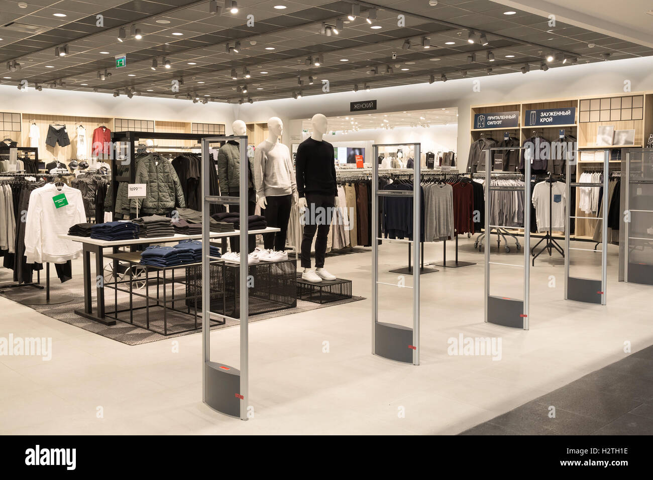 Mens clothes hanging on hangers in store Stock Photo - Alamy