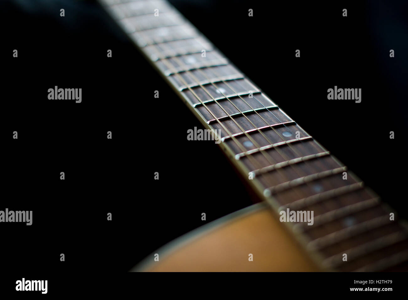 Guitar neck and strings laying on its side in a music studio Stock ...