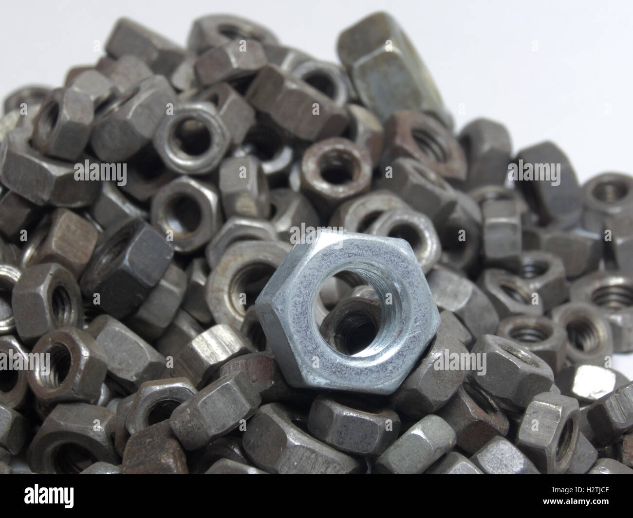 a pile of old nuts. Focus on the white hex nut Stock Photo - Alamy