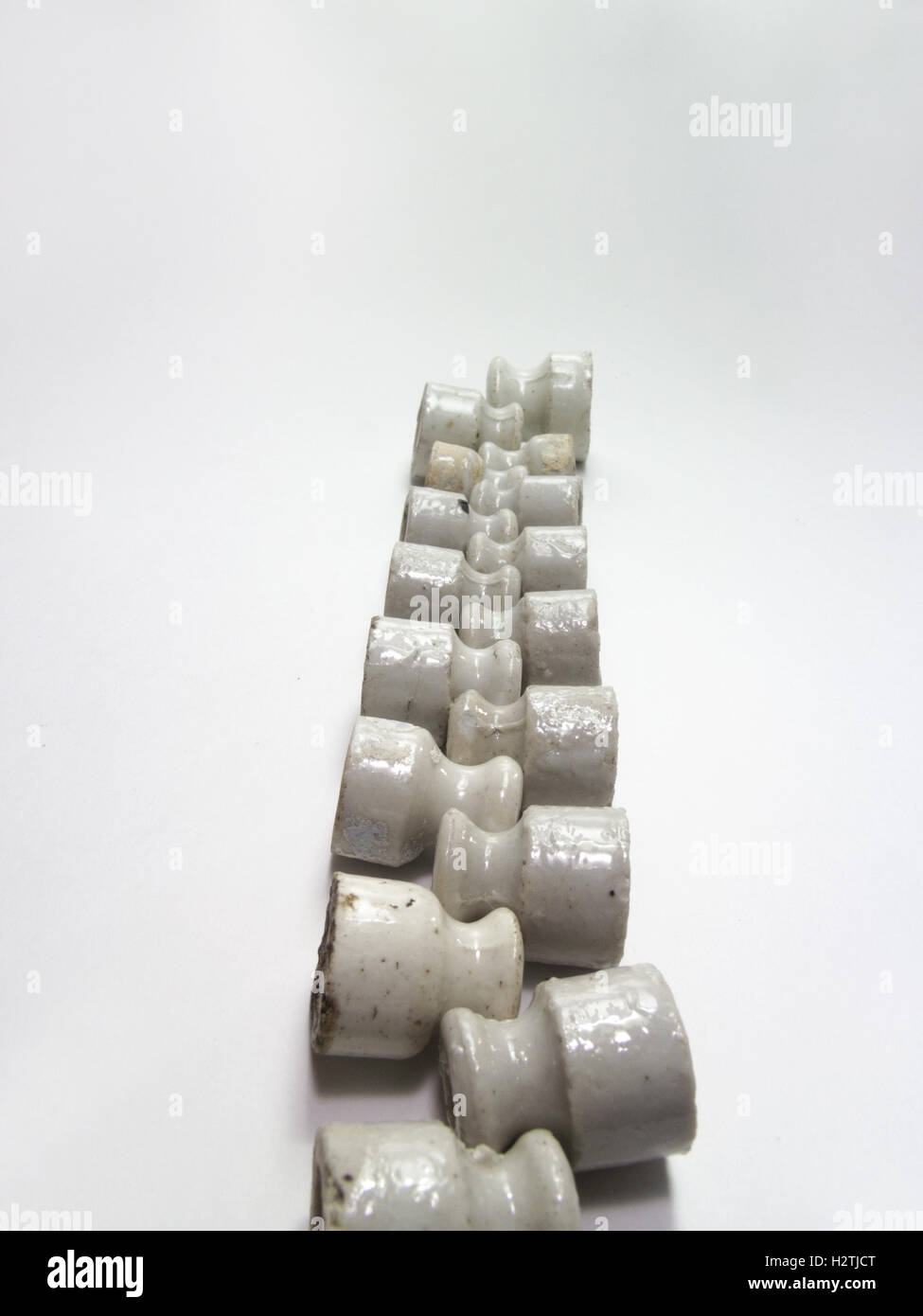 a trail of ceramic insulators small size Stock Photo - Alamy