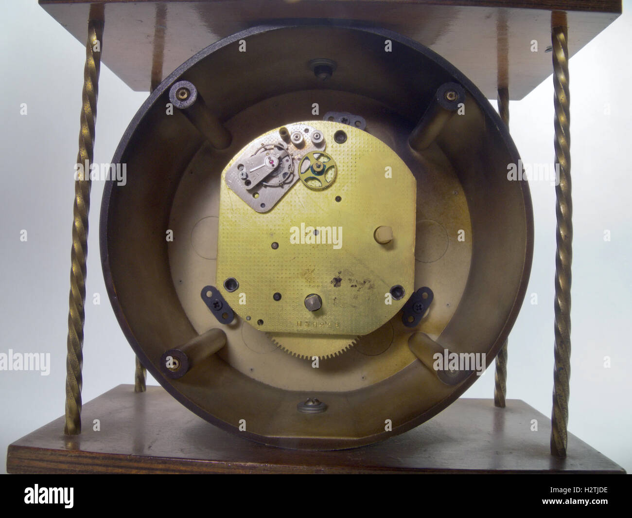 Antique clock with open the back cover and a view of the mechanism ...