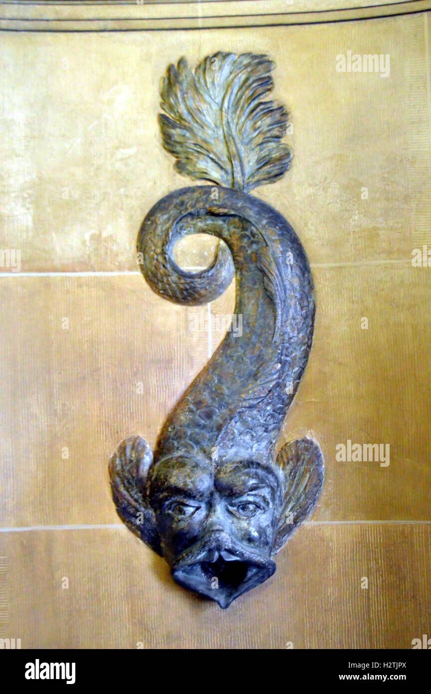 Bronze fish on a wall with a human head Stock Photo - Alamy