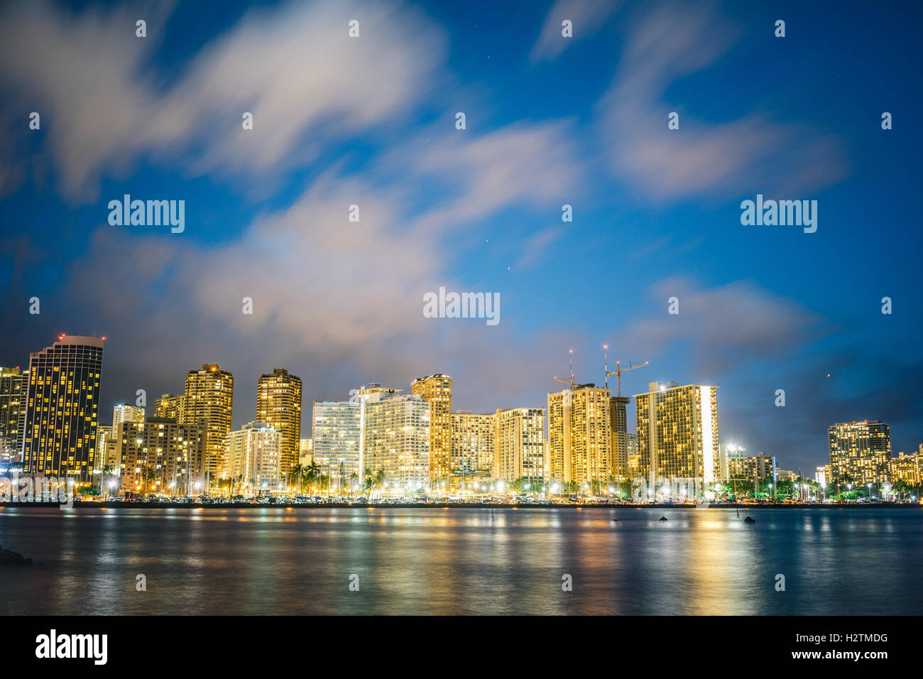 A night view of a section of Honolulu skyline viewed from Magic Island ...