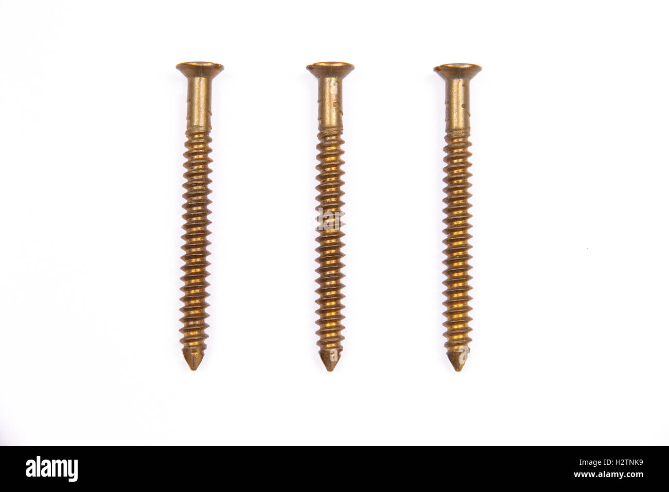 Three screws on white background Stock Photo - Alamy