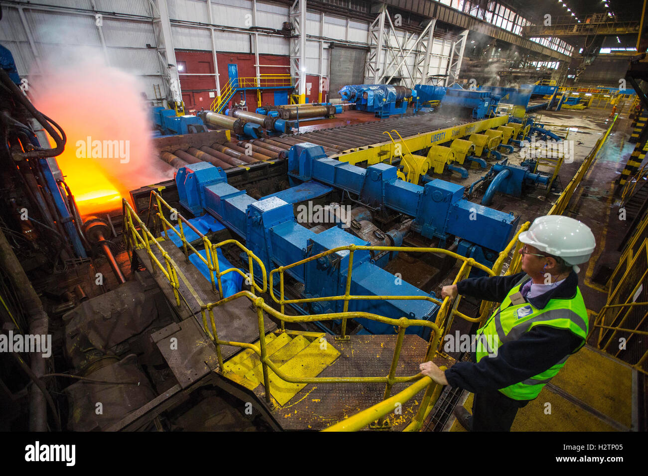 red hot steel being pressed in steel works Stock Photo - Alamy