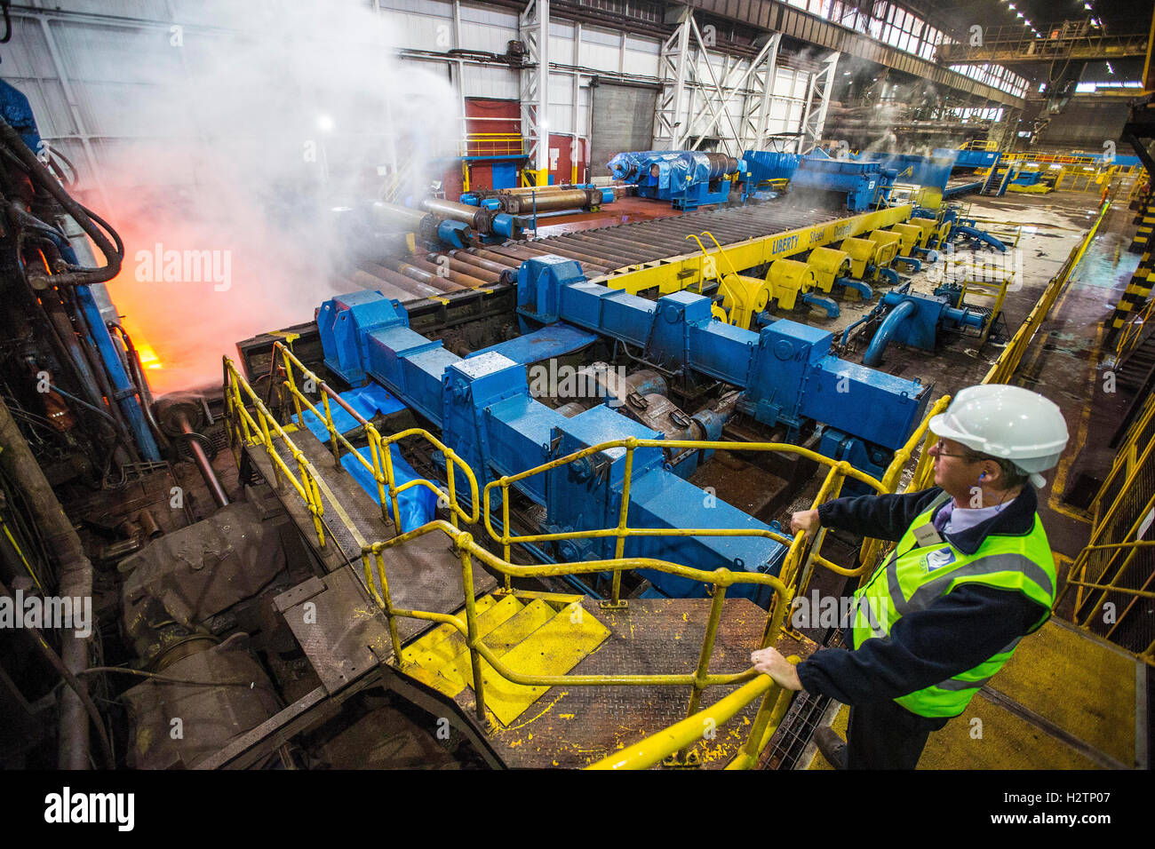 red hot steel being pressed in steel works Stock Photo - Alamy