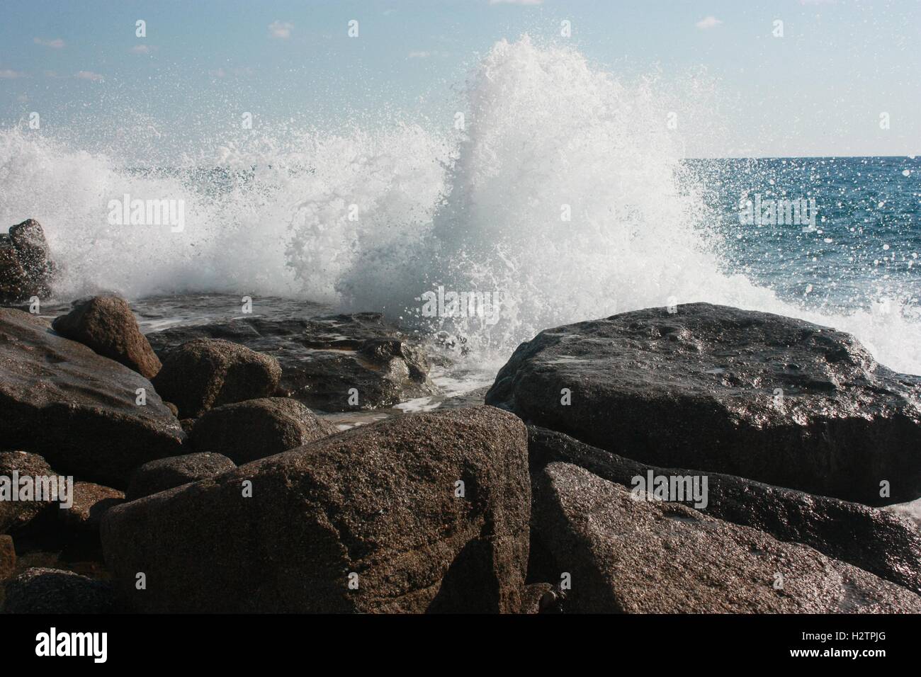 The stone beach and a wave Stock Photo - Alamy